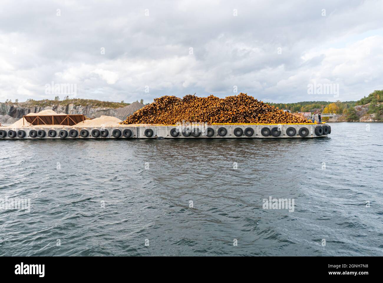 Big piles of timber stored on a quay Stock Photo - Alamy