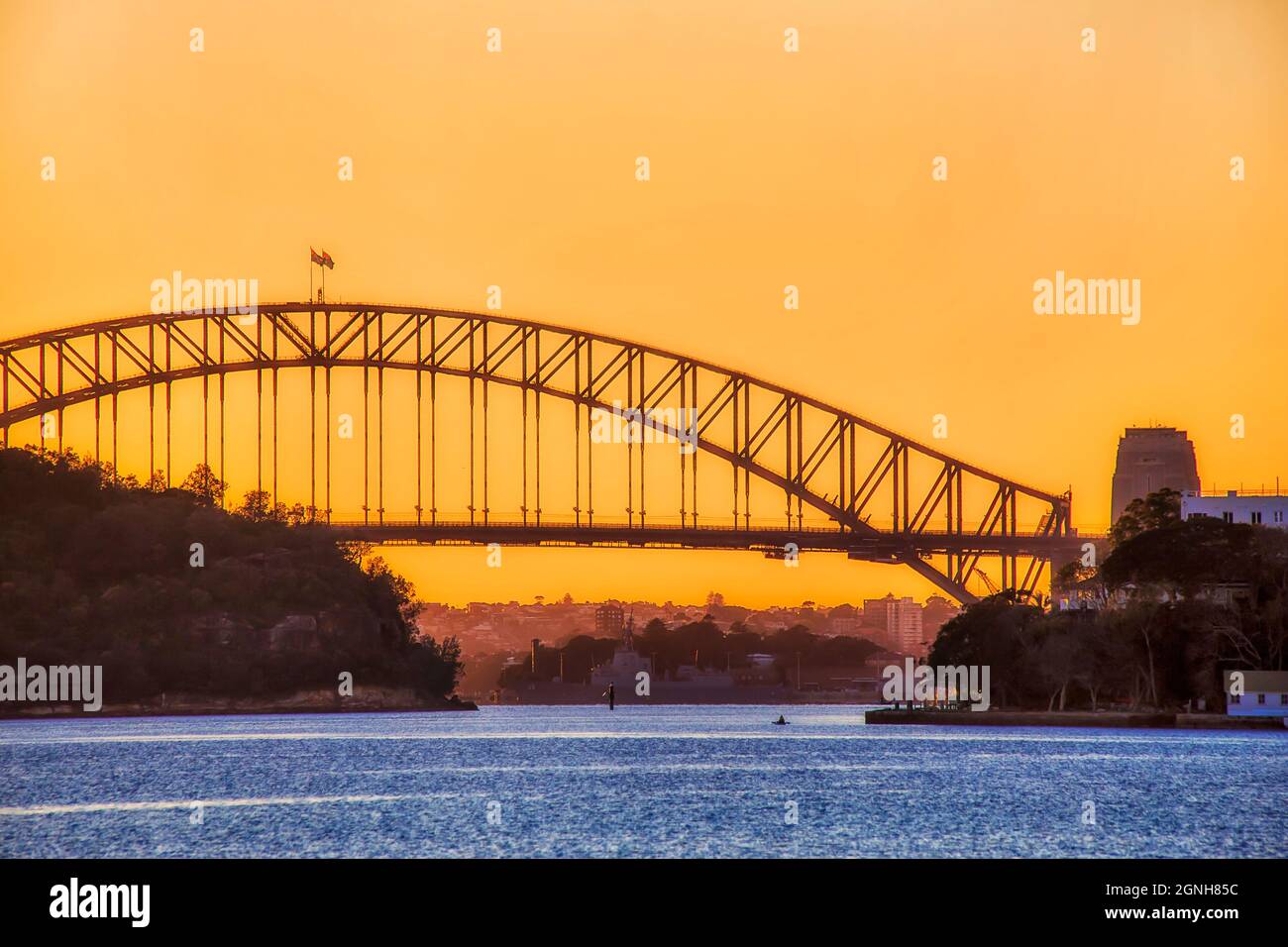 Fragment of Sydney Harbour bridge arch against yellow sky at sunrise ...