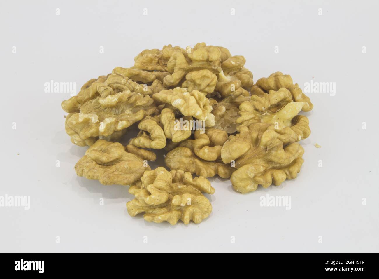 Group of peeled walnuts with a white background Stock Photo - Alamy