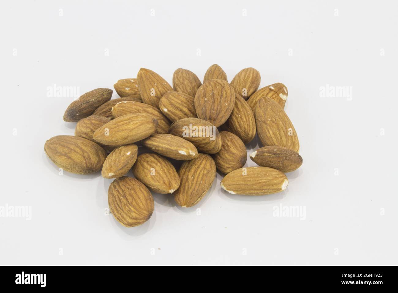 Bunch of brown almonds with a white background Stock Photo - Alamy