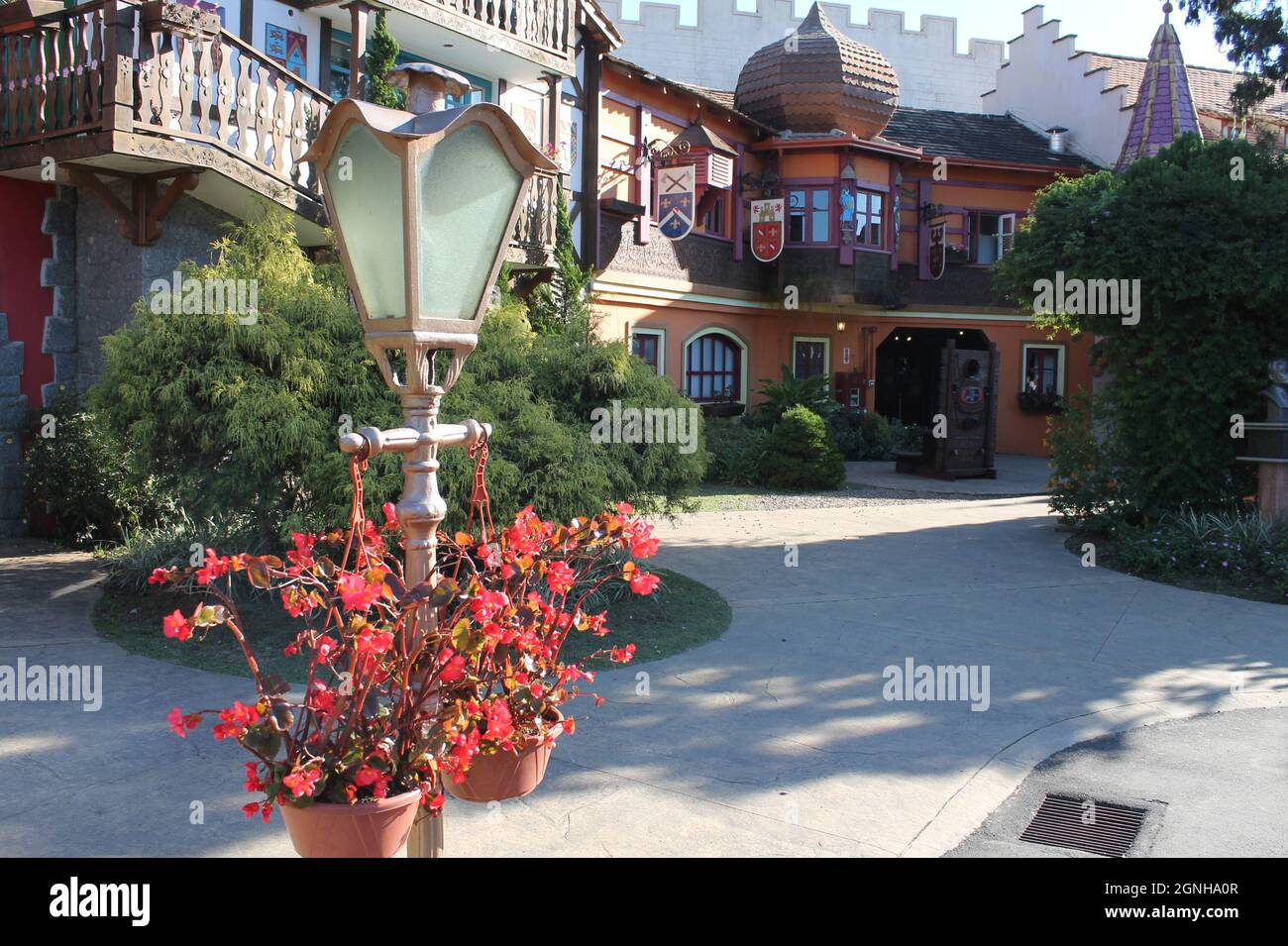 Lamppost with pots of flowers hanging from its sides in the courtyard ...