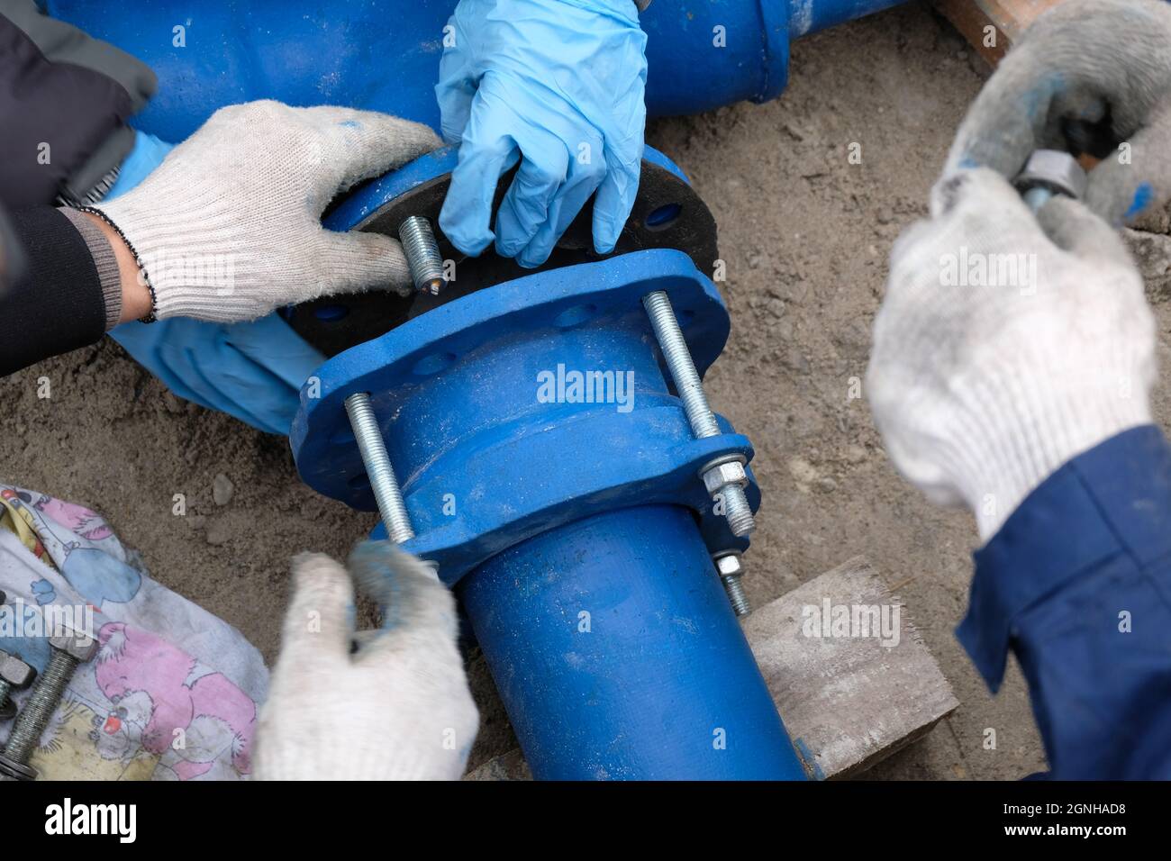 Workers installing water supply pipeline system, close up Stock Photo ...