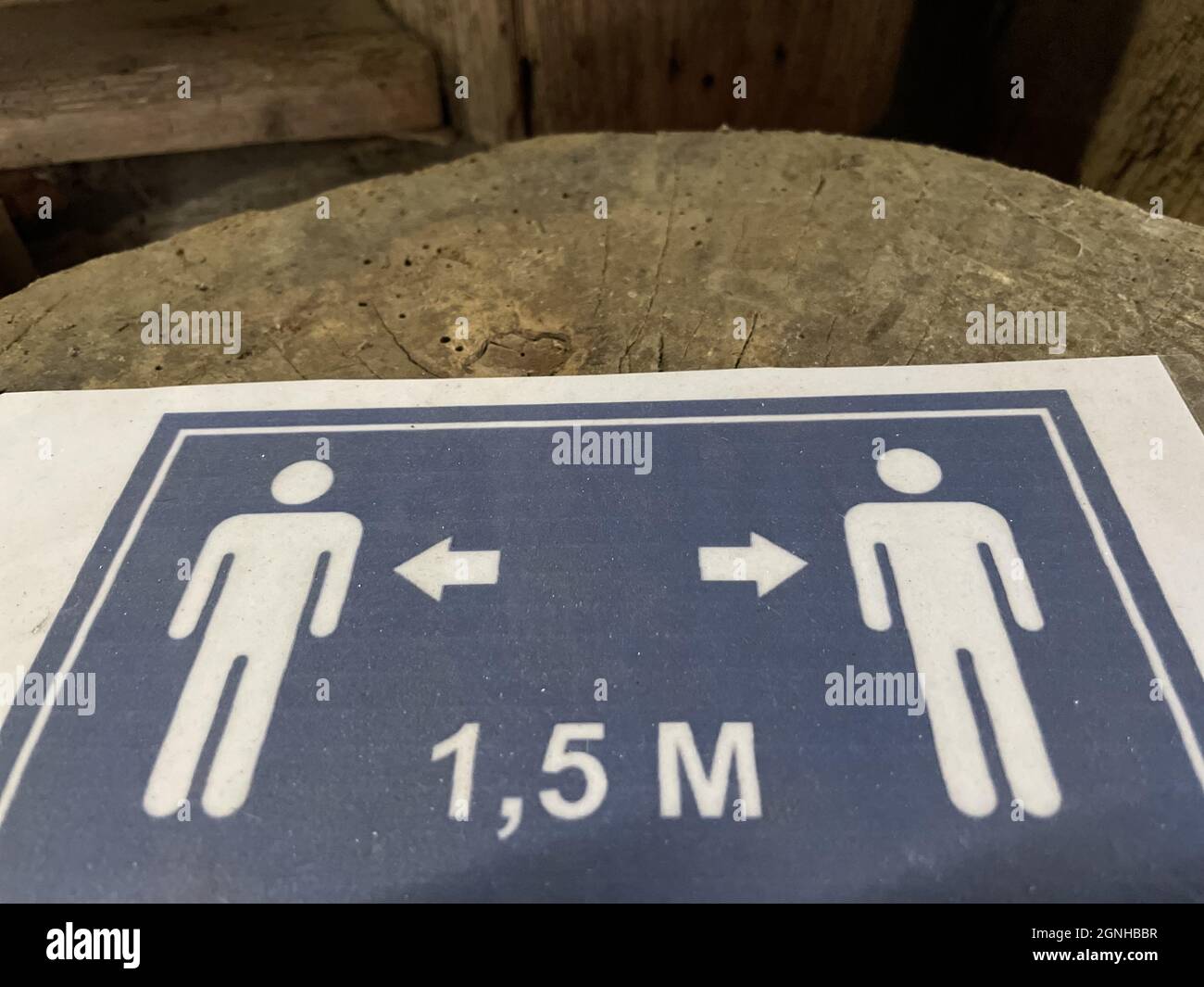 Sign depicting two figures standing apart from each other, indicating ...