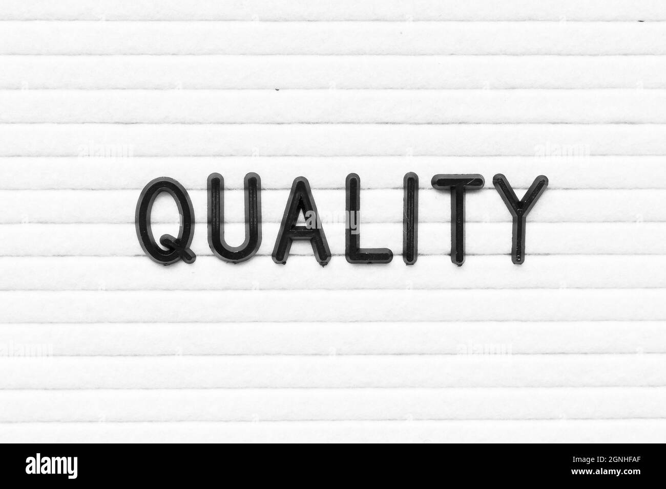 Black letter in word quality on white felt board background Stock Photo ...