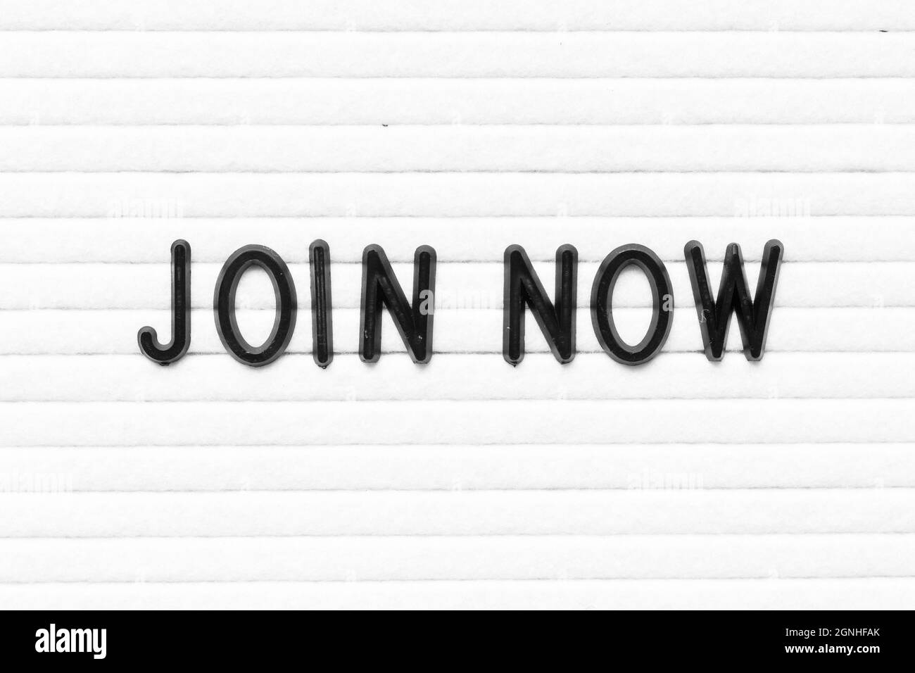 Black letter in word join now on white felt board background Stock ...