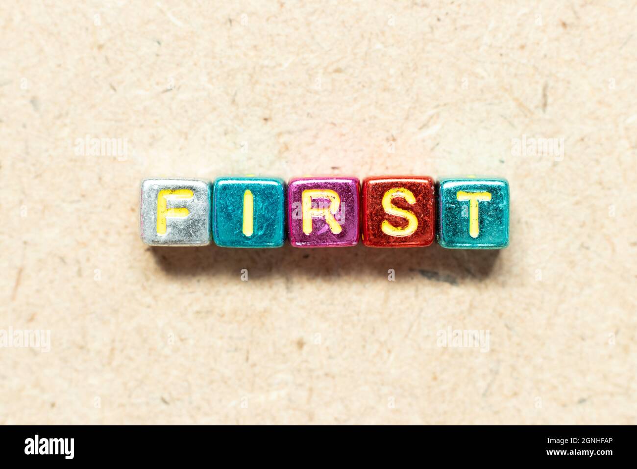 Metallic color alphabet letter block in word first on wood background ...