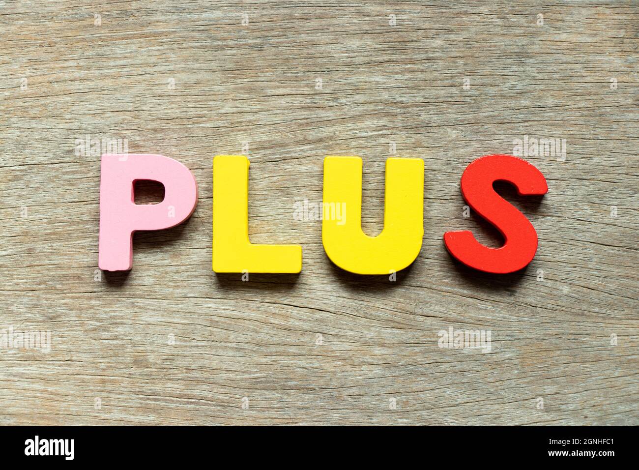 Color alphabet letter in word plus on wood background Stock Photo - Alamy