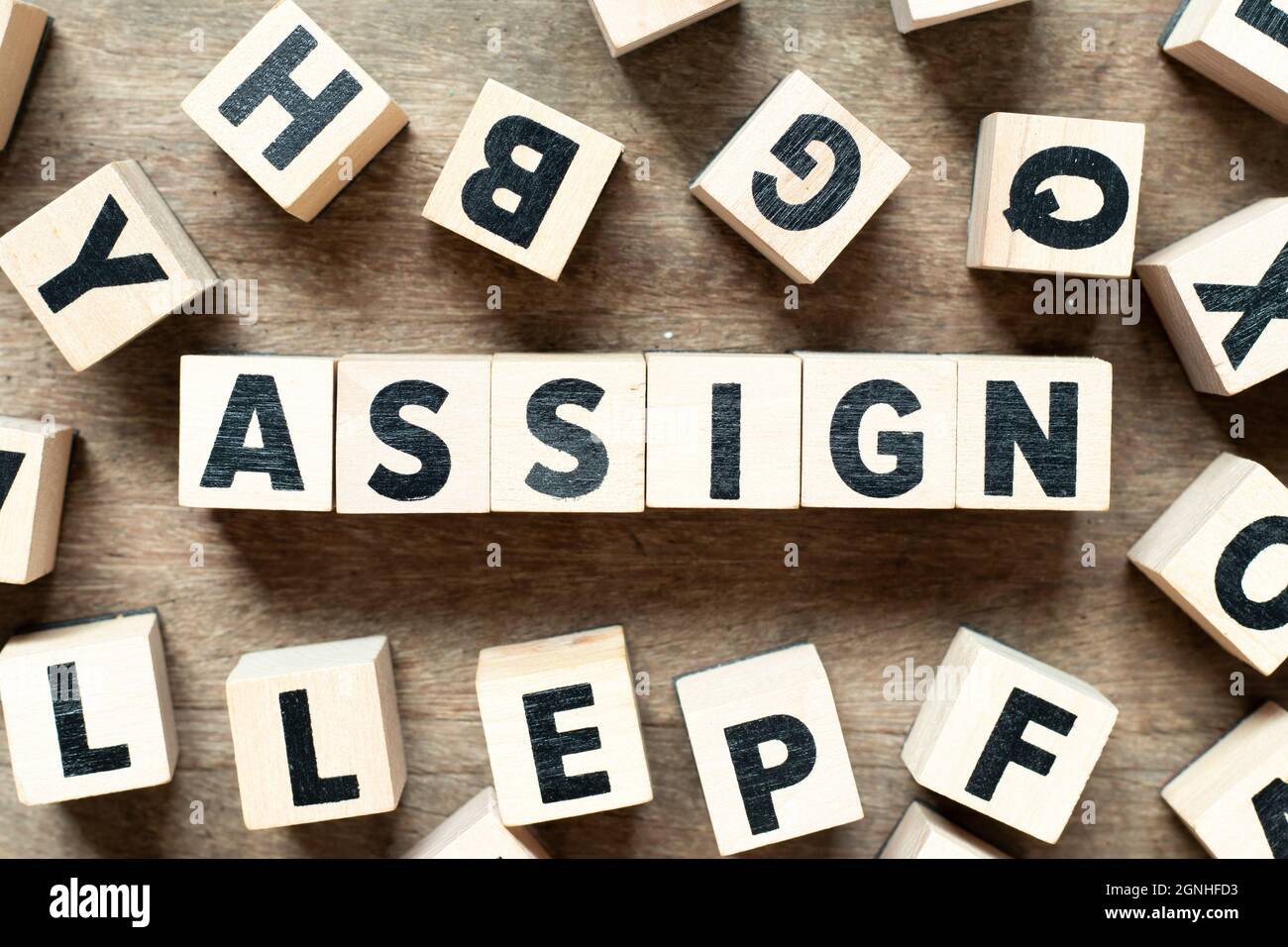 Alphabet letter block in word assign with another block on wood ...