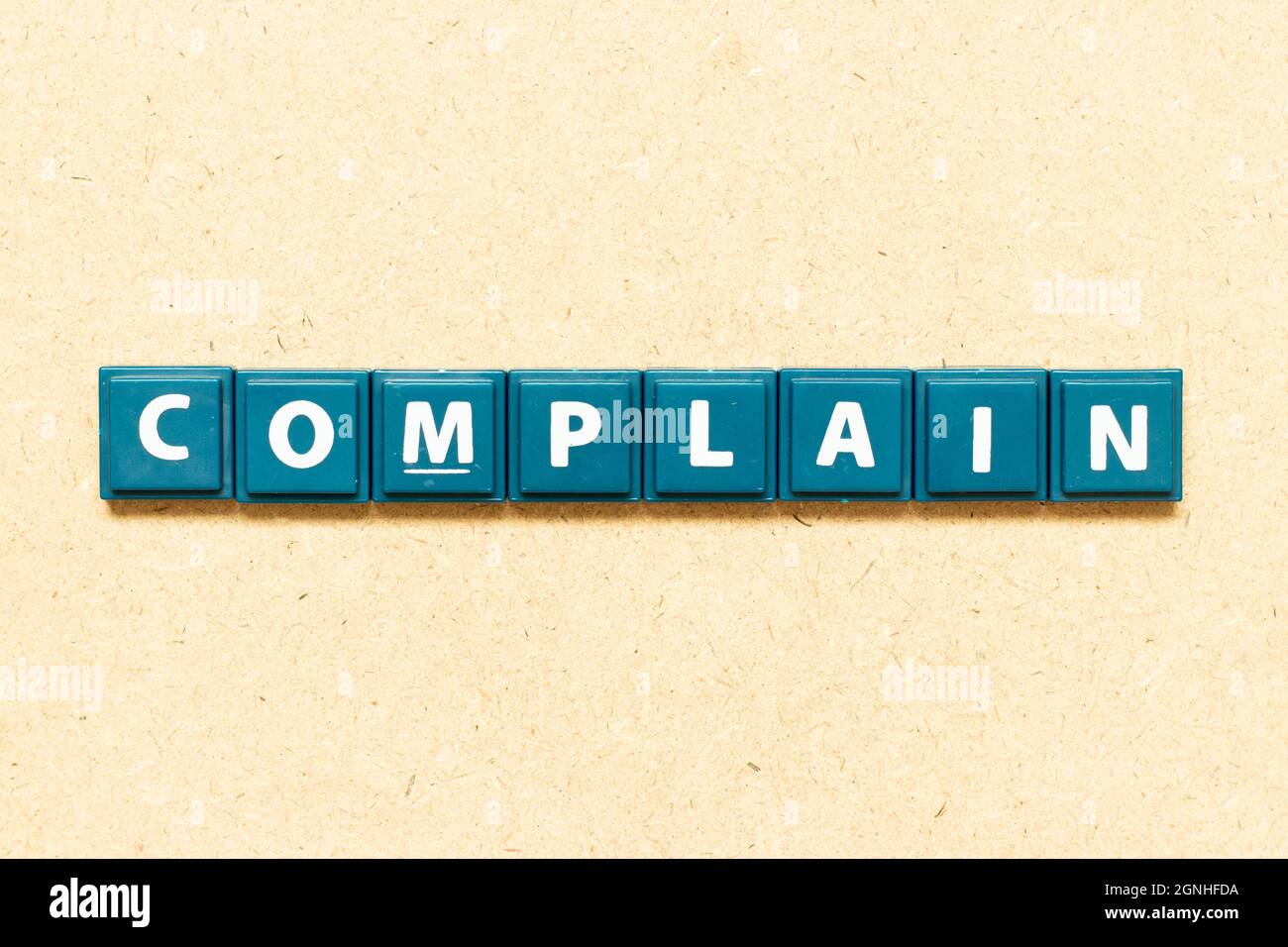 Tile alphabet letter in word complain on wood background Stock Photo ...