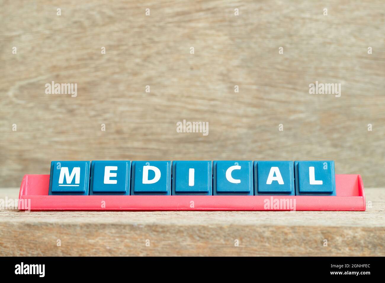 Tile alphabet letter with word medical in red color rack on wood ...