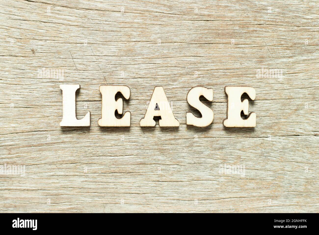 Alphabet letter in word lease on wood background Stock Photo - Alamy