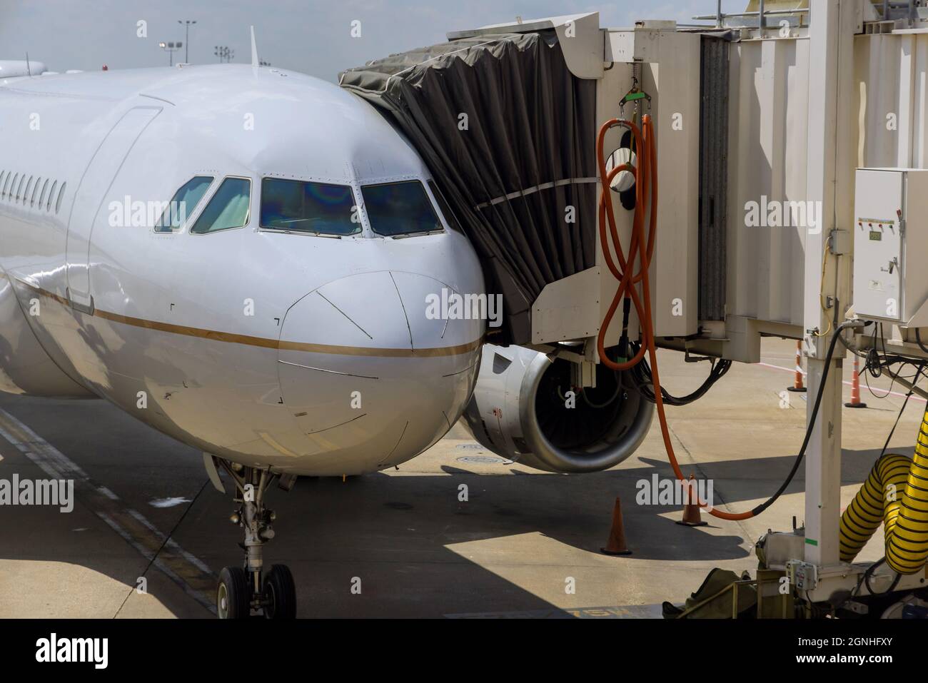 Boarding bridge jetway connected to the airplane for boarding ...