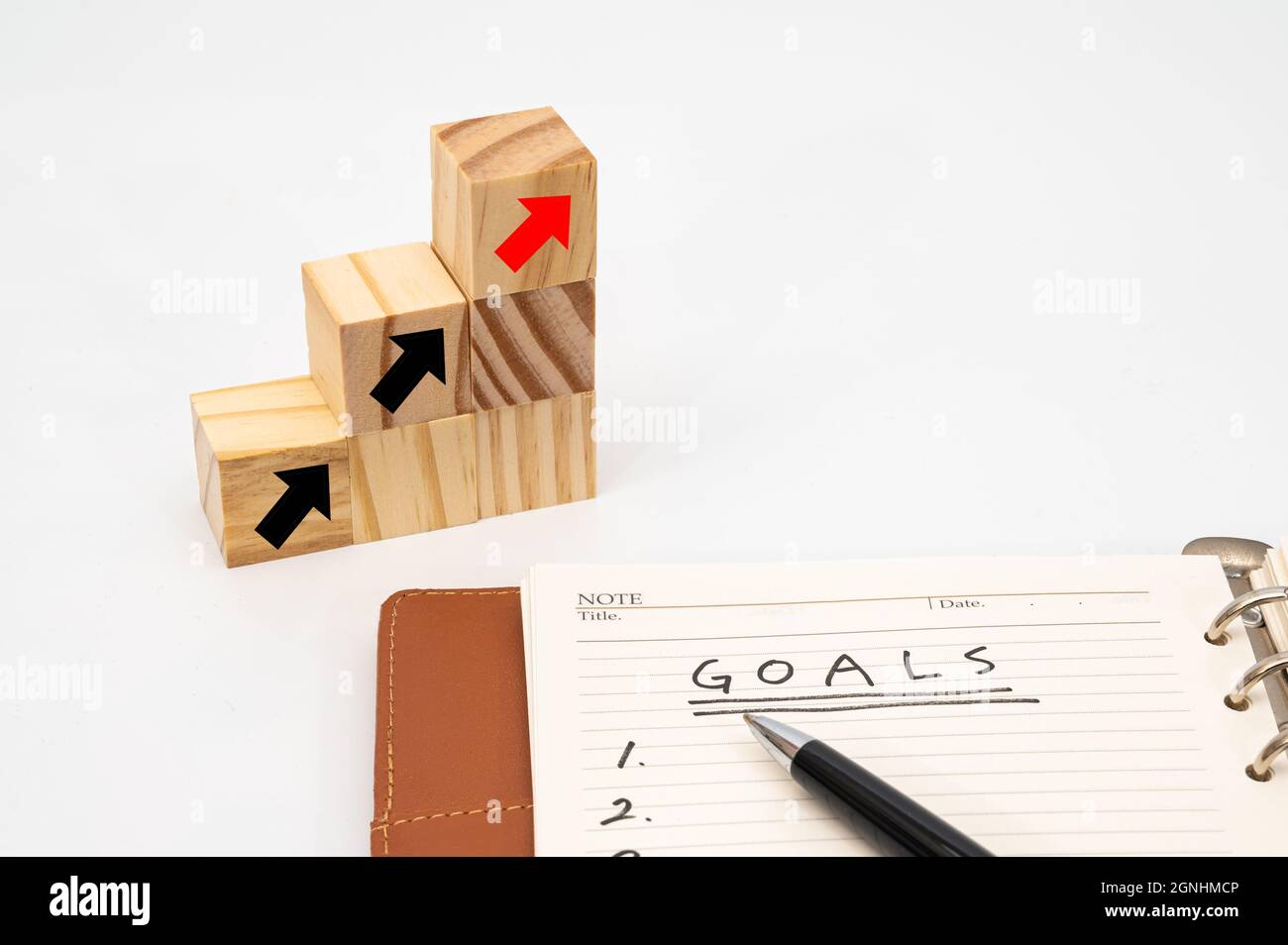 Wooden cube staircase with goal list and arrows. Business concept of ...