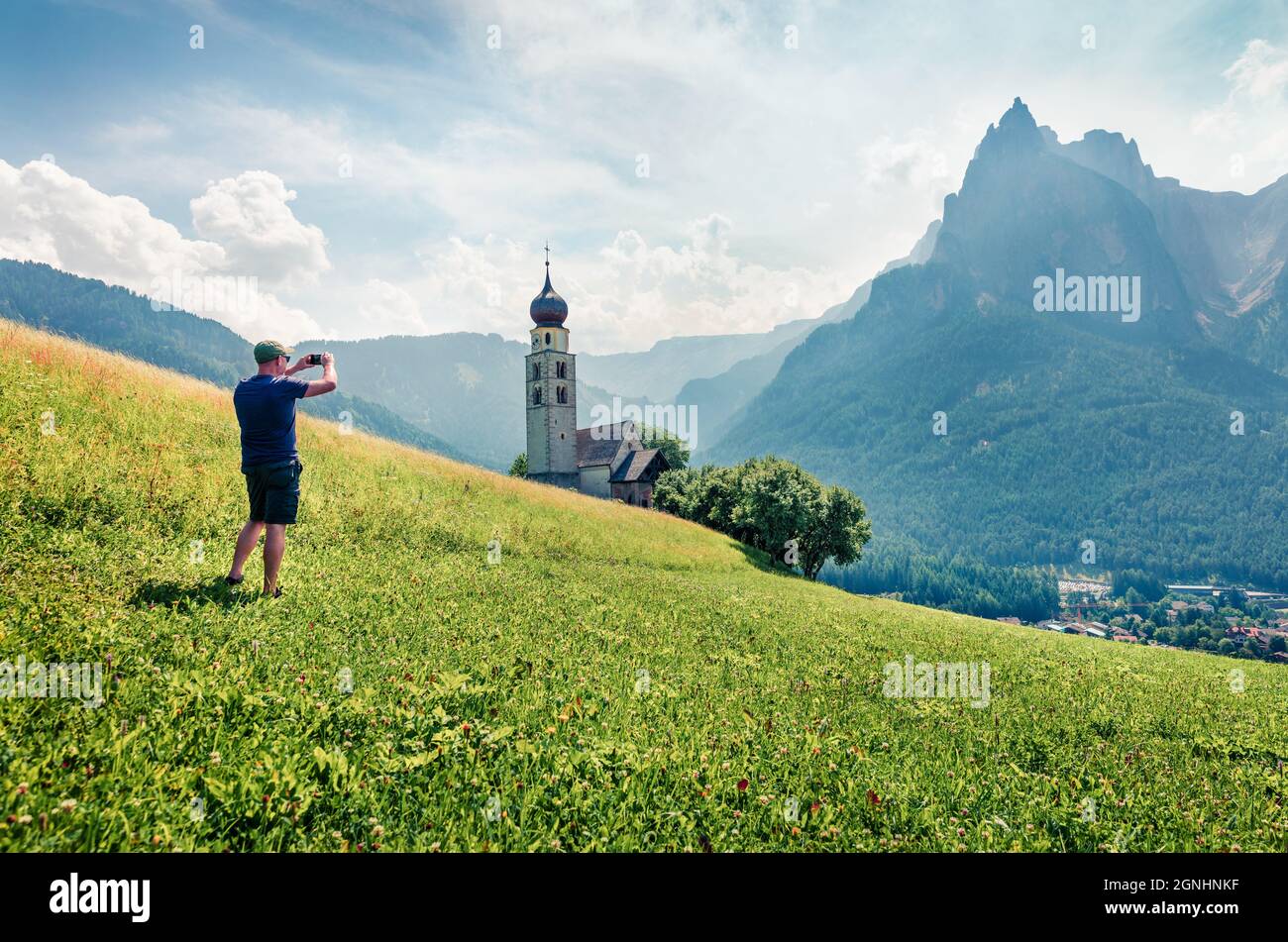 Photographer makes a photo of San Valentino Church in Castelrotto ...