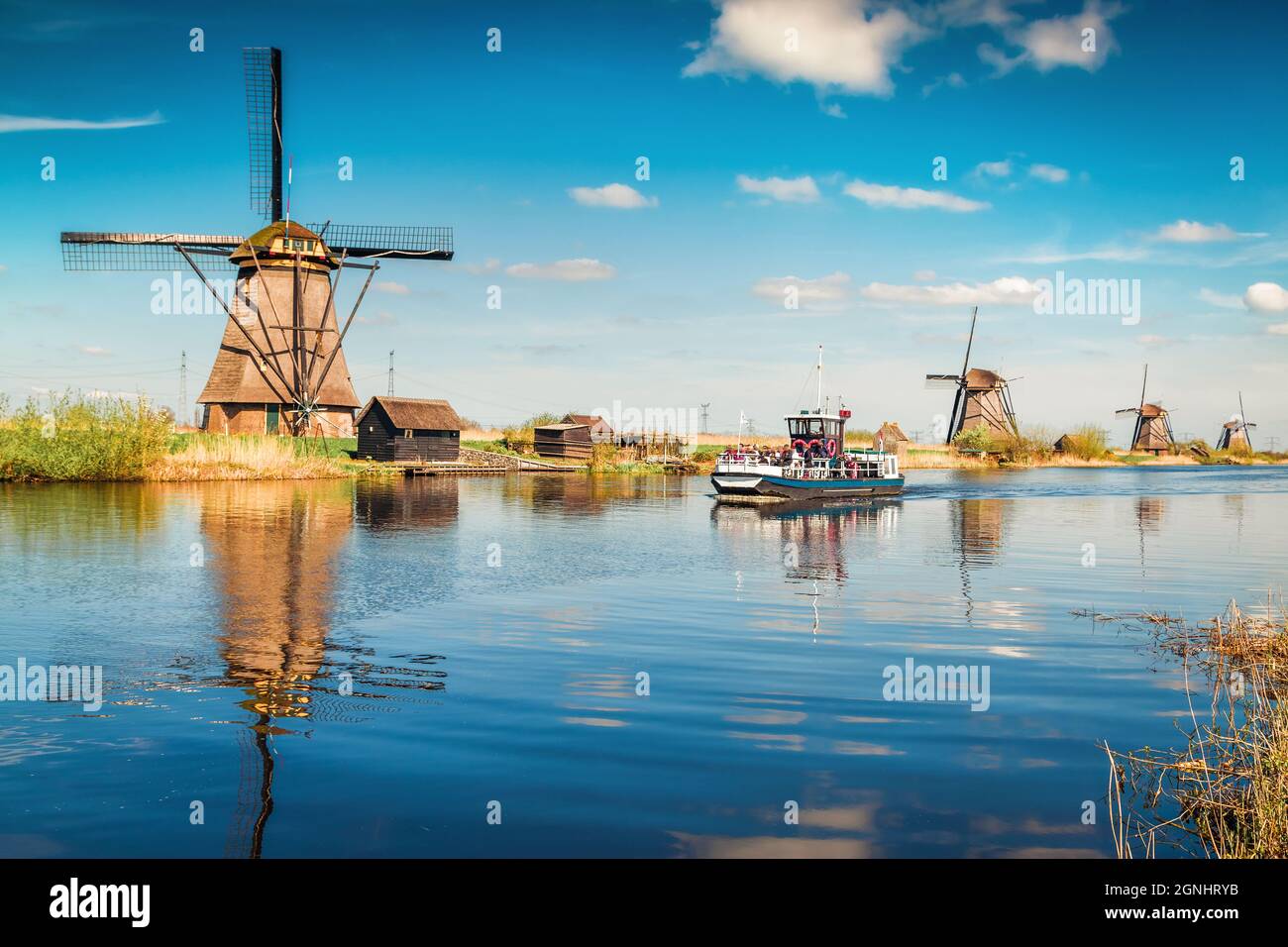 Walking boat on the famoust Kinderdijk canal with windmills. Old Dutch ...