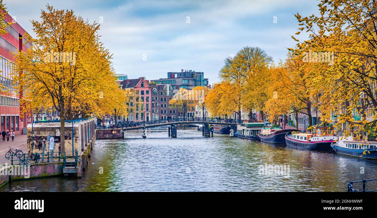 Captivating autumn scene of Amsterdam city. Famous Dutch channels and ...