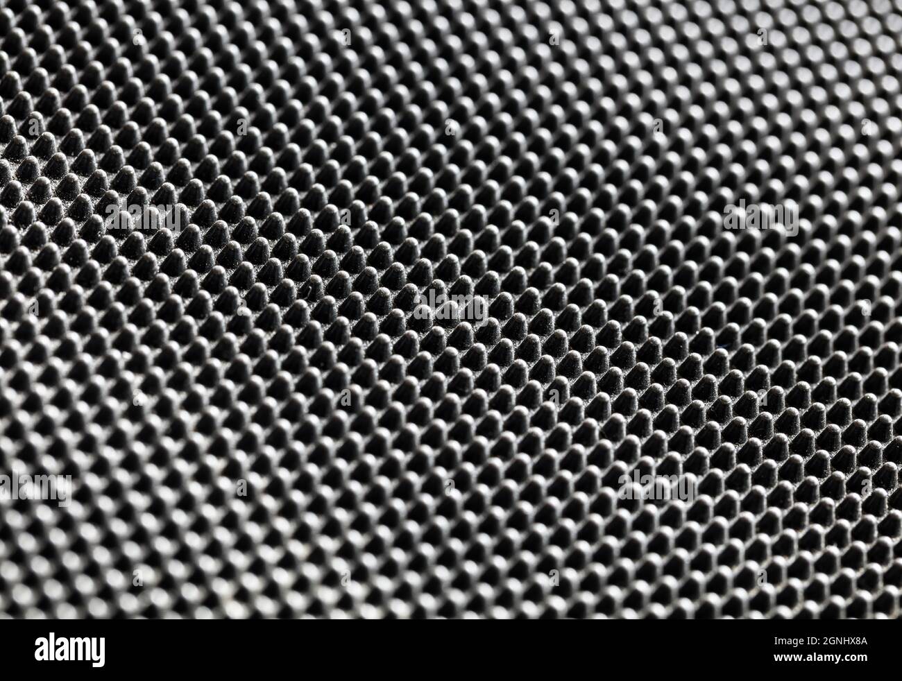 Black bumpy rubber surface used as a background. Black and white ...