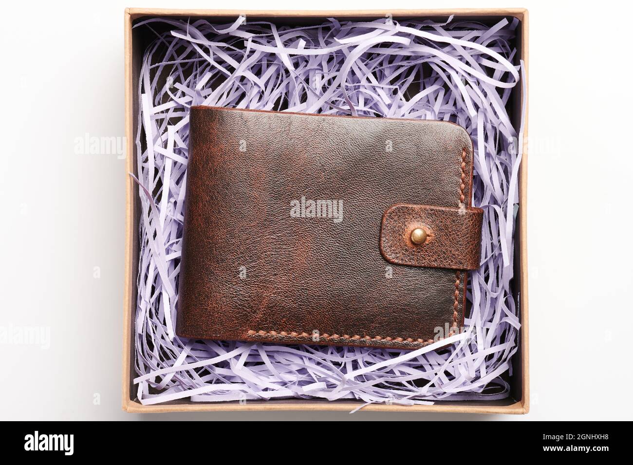 Genuine leather brown wallet in paper open box above top view isolated ...