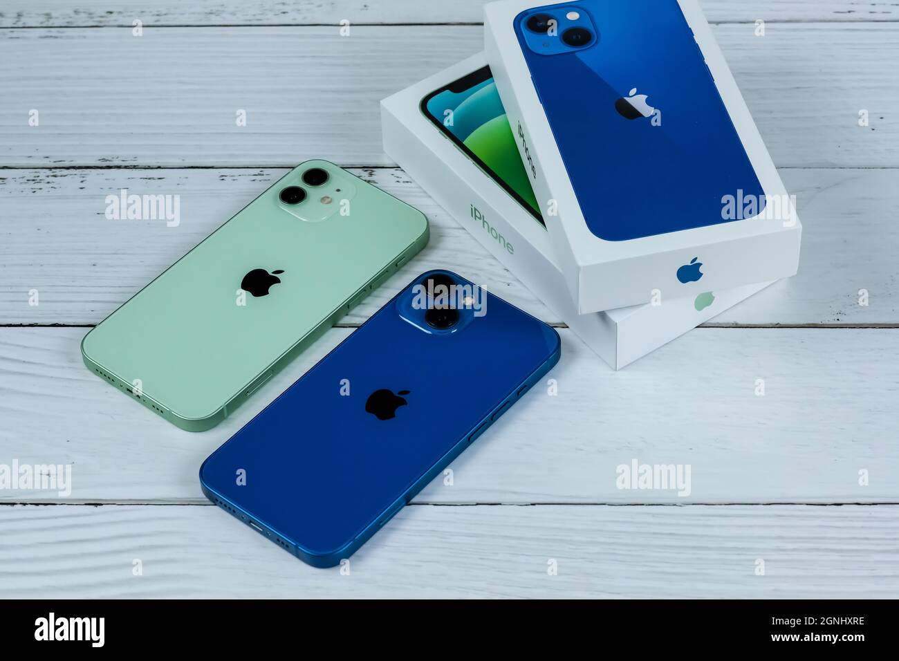 iPhone 13 in blue and iPhone 12 in green Stock Photo - Alamy