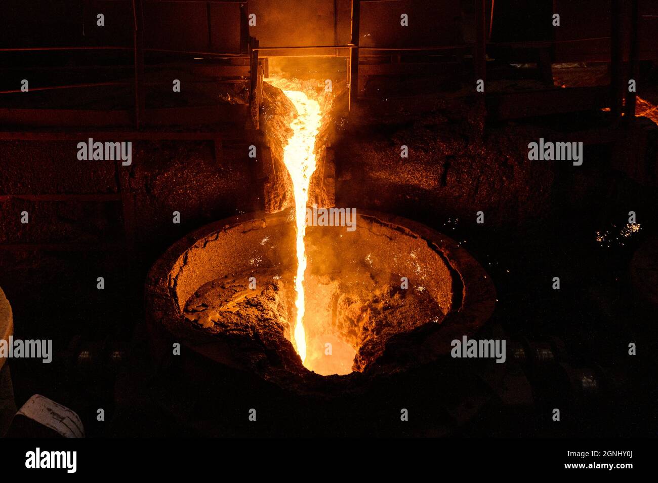 A stream of molten slag is poured into a metallurgical ladle Stock ...