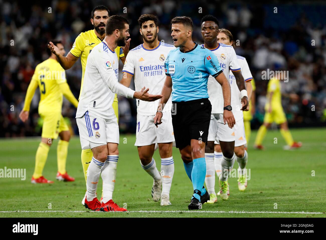 Nacho Fernandez of Real Madrid with a referee during the La Liga match ...