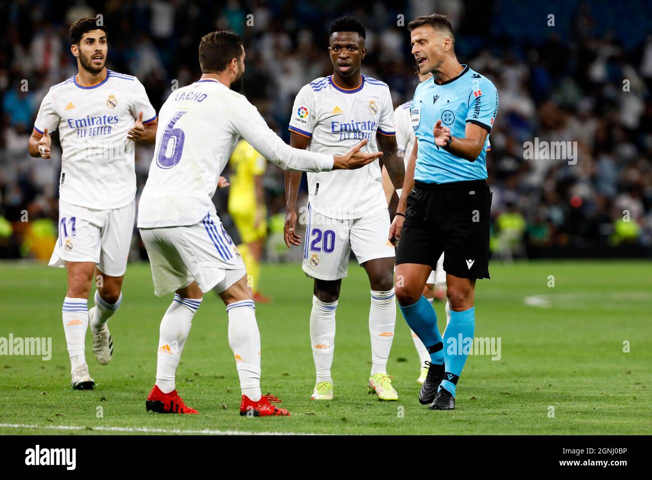 Nacho Fernandez of Real Madrid with a referee during the La Liga match ...
