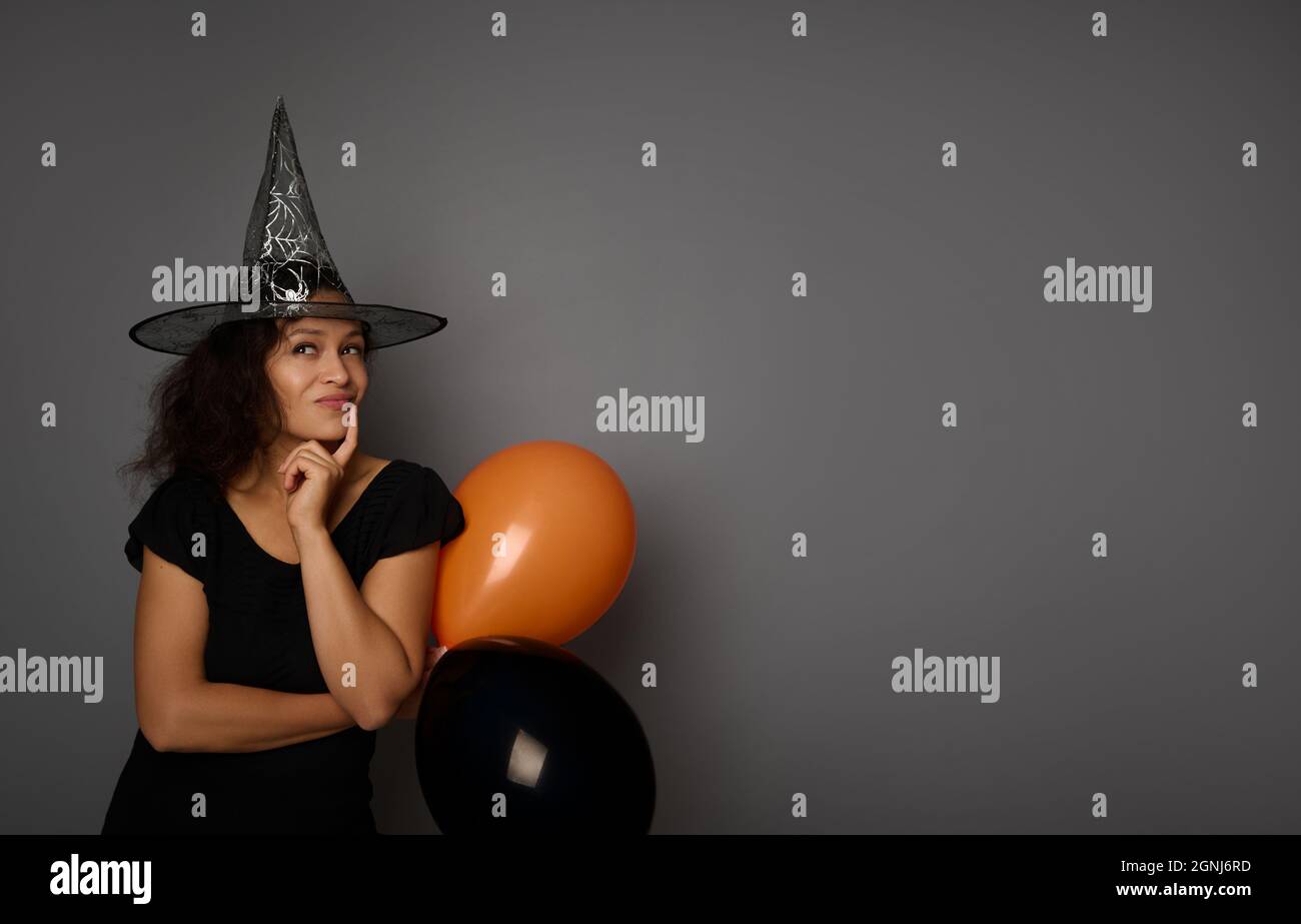 Beautiful mysterious pensive young mixed race woman in black and wizard ...