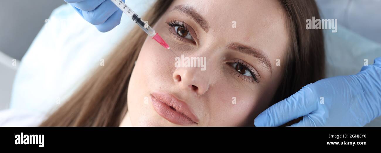Young woman receiving anti-aging injection in beauty clinic Stock Photo ...