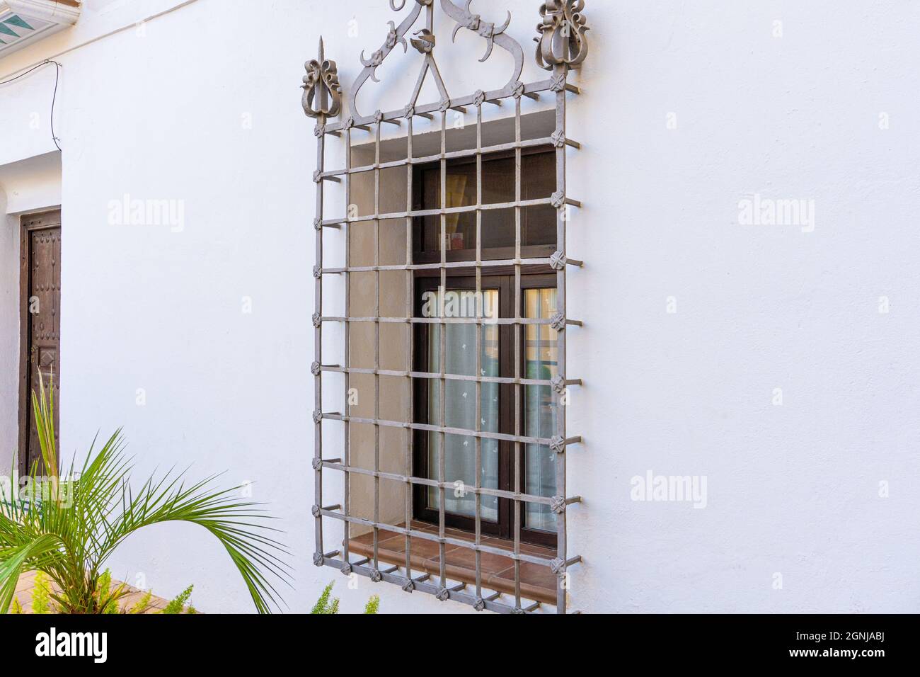 A white house window with a security cage Stock Photo - Alamy