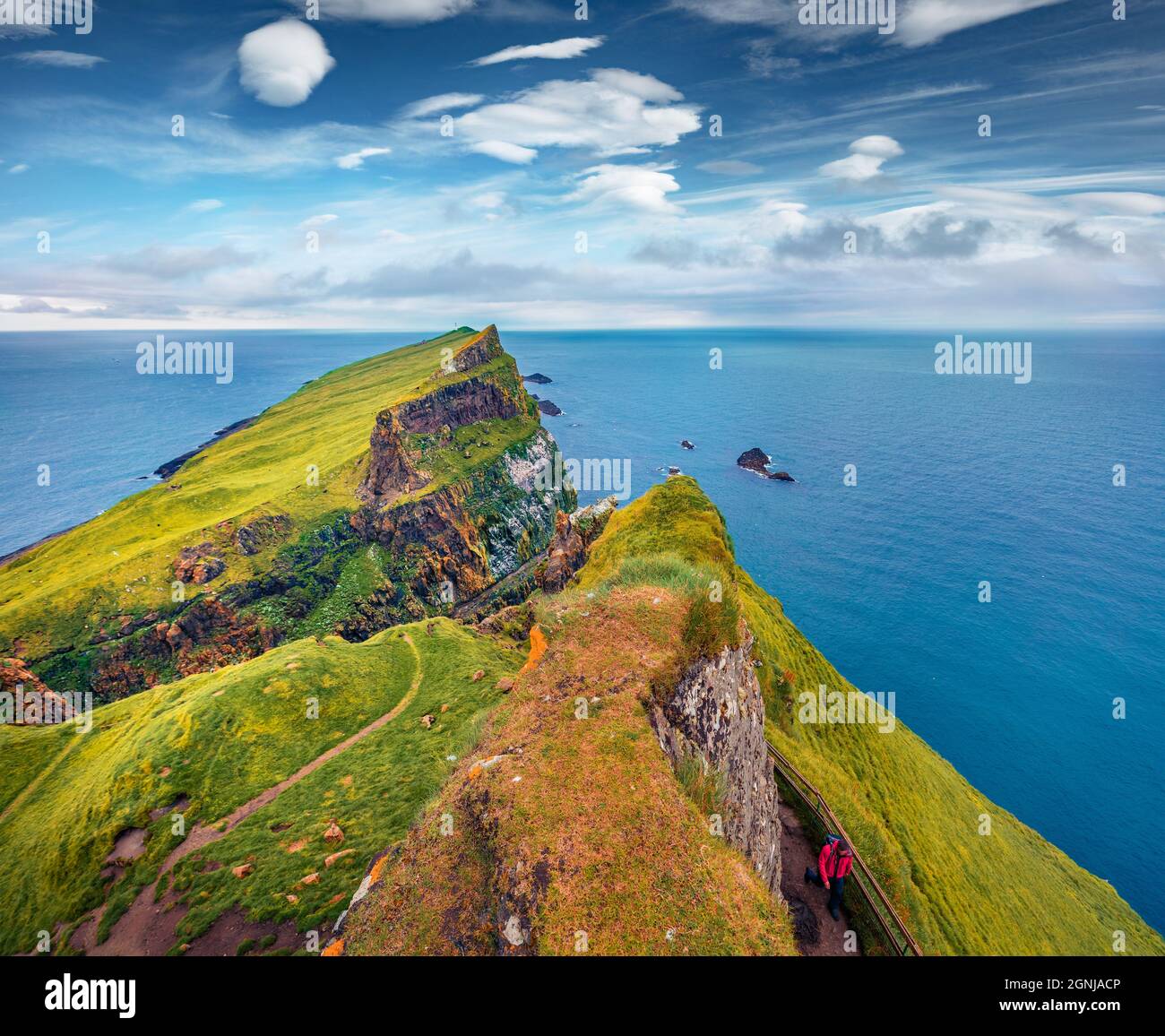 Tourist on the trek on Mykines island. Gloomy summer view of Faroe ...