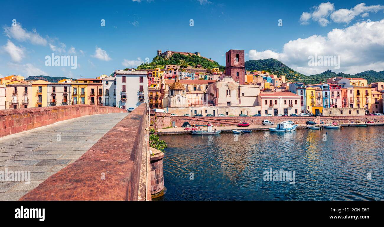 Colorful summer cityscape of Bosa town with Ponte Vecchio bridge across ...