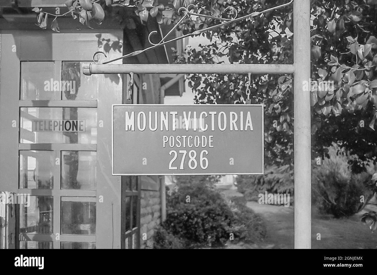 A sign in the town near an old telephone box marking the town of Mount ...