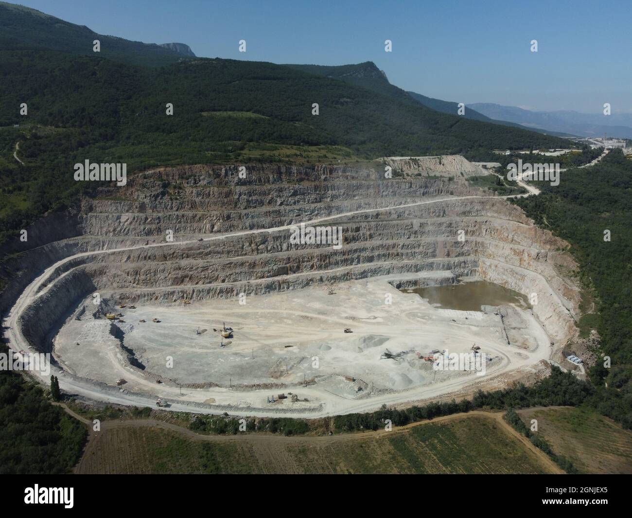 Aerial view industrial of opencast mining quarry with lots of machinery ...