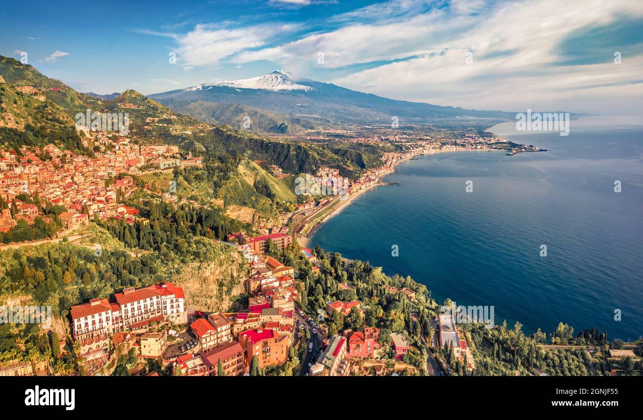 View from flying drone of Taormina town and Etna volcano on background ...