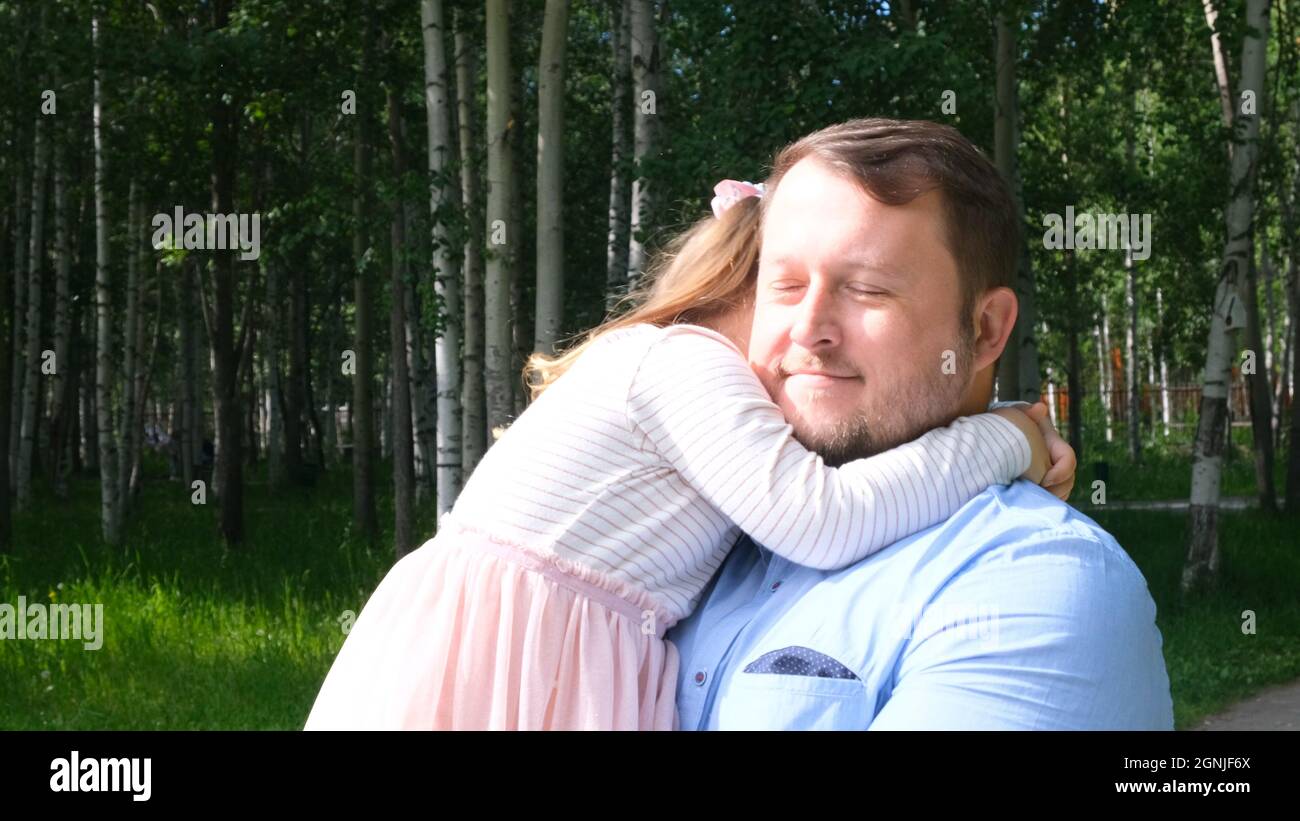 Happy father carrying around his neck and hugging daughter 4-5 years ...