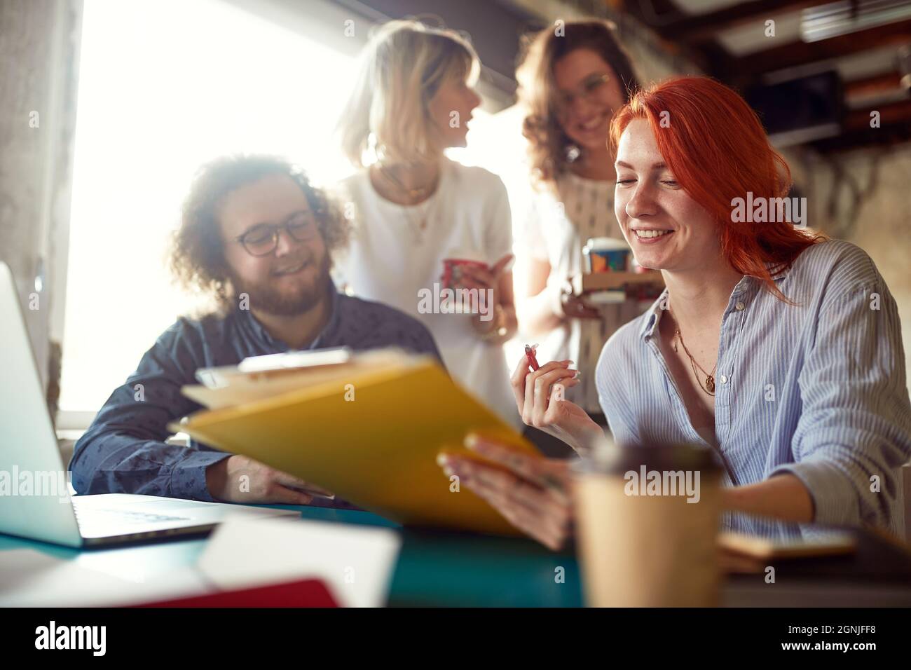 Group of young colleagues are in a good mood while working together in ...