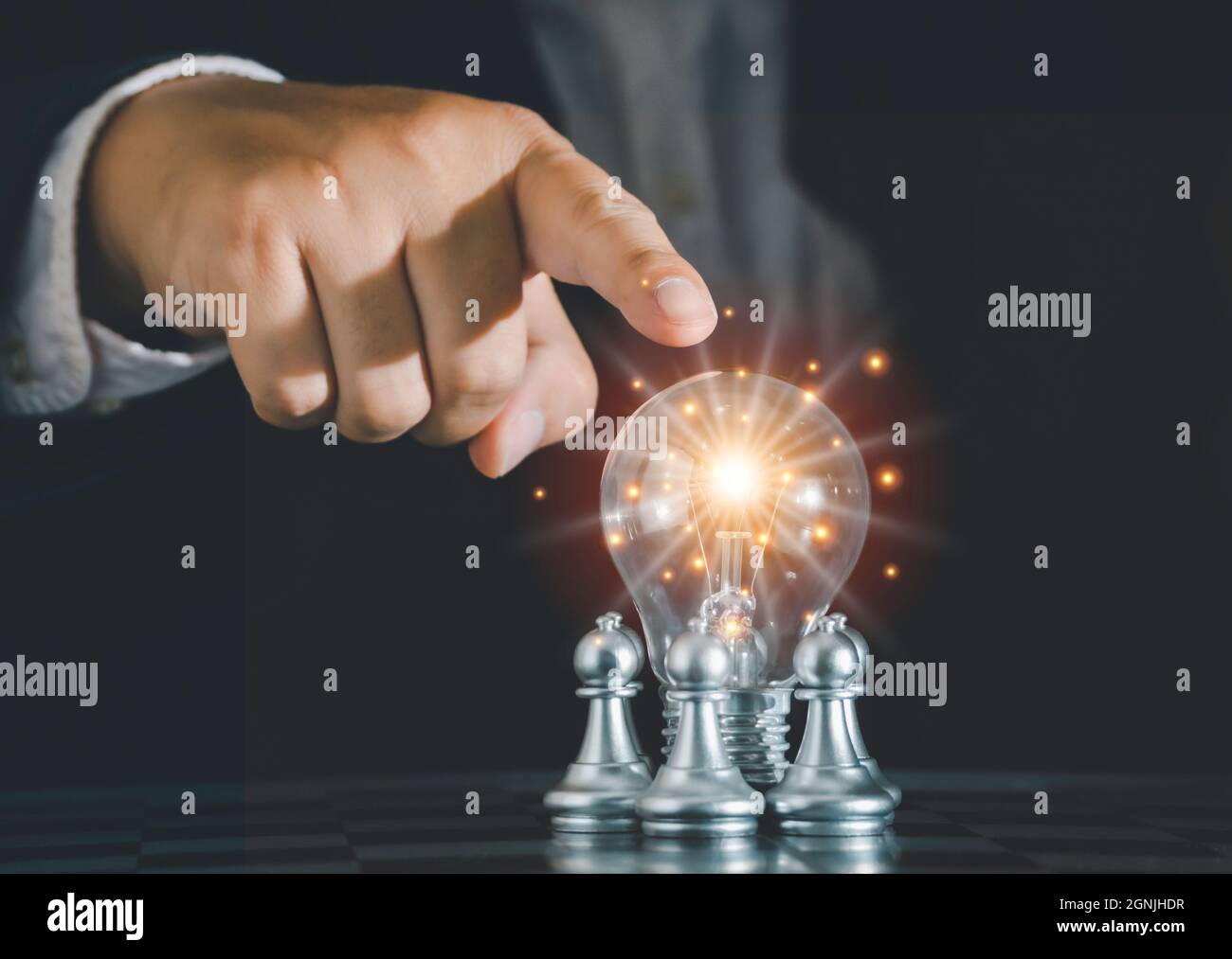 Hand of businessman pointing light bulb with fire spark shine glitter ...