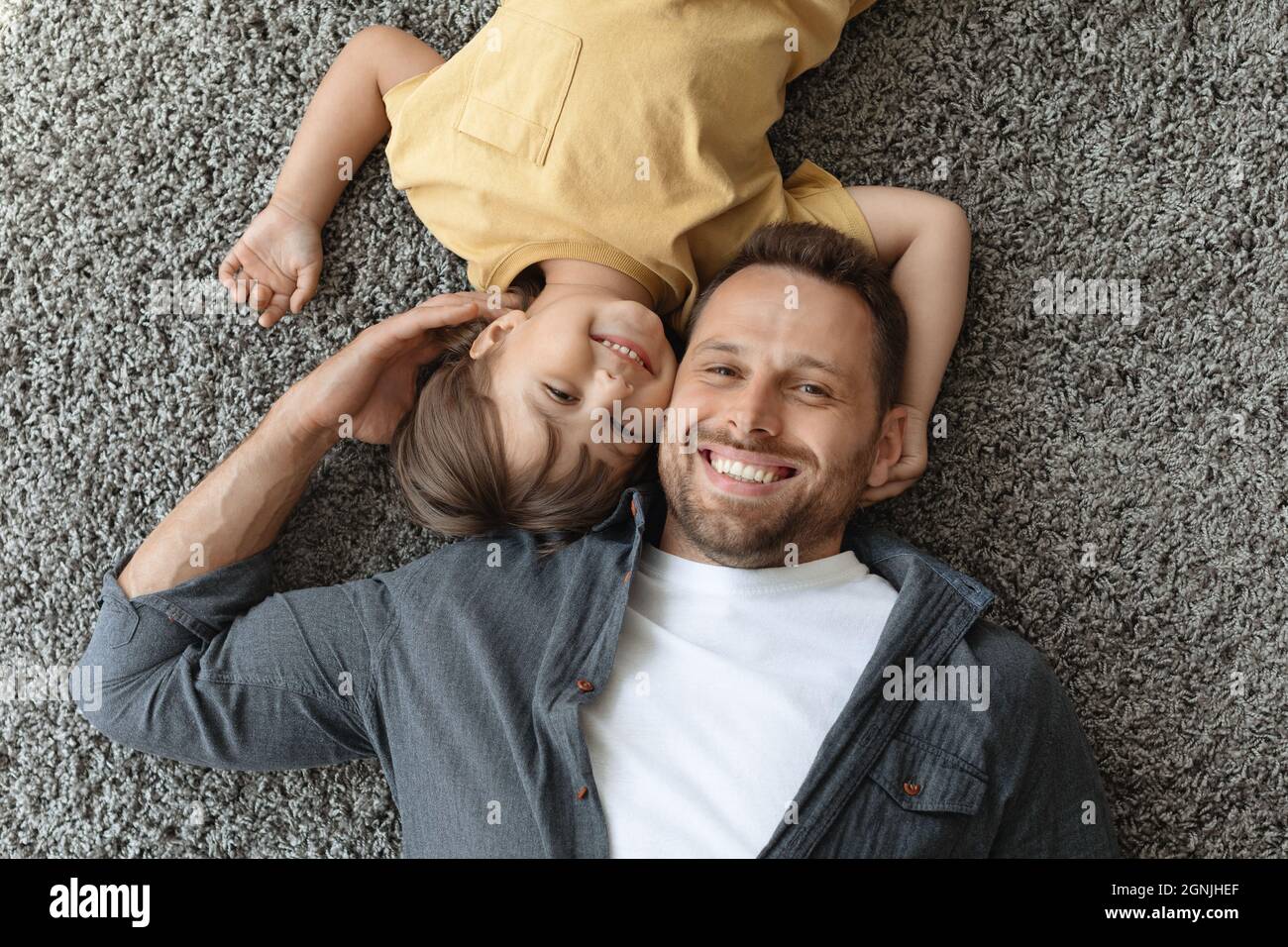 Happy dad and son. Top view of young positive father and his little son ...
