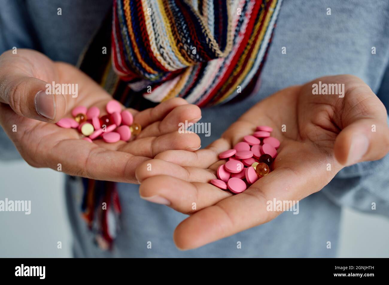 sick man in a sweater with pills in hand health problems light ...