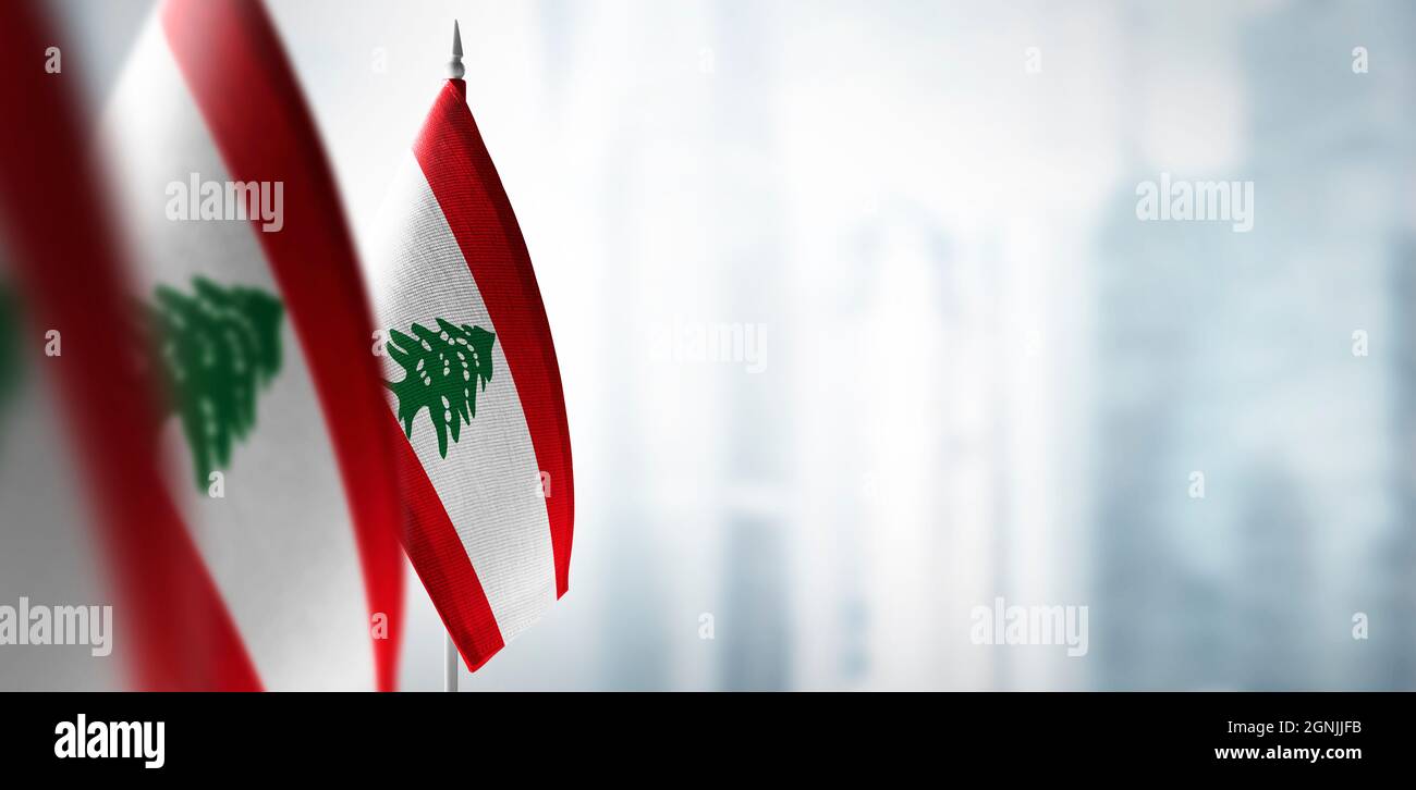 Small flags of Lebanon on a blurry background of the city Stock Photo ...