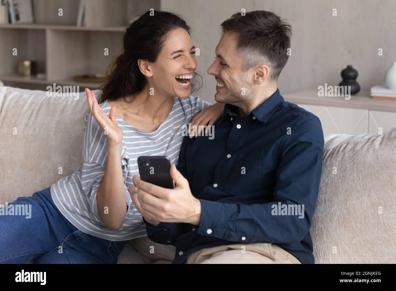 Cheerful young family couple celebrating getting online lottery win ...