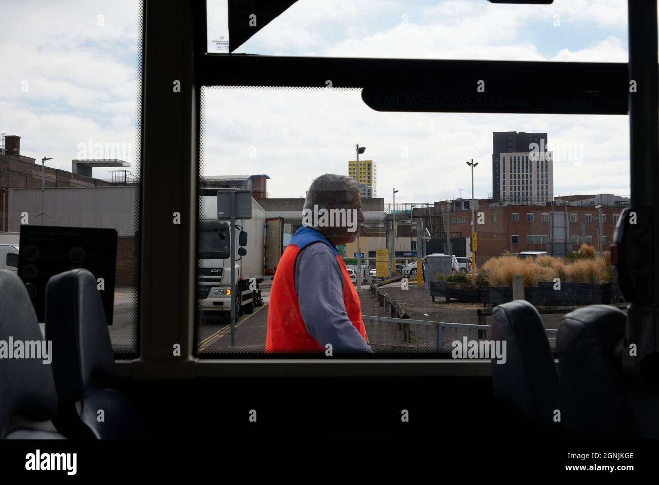 Man in orange jacket seen moving fast outside the window of a bus Stock ...