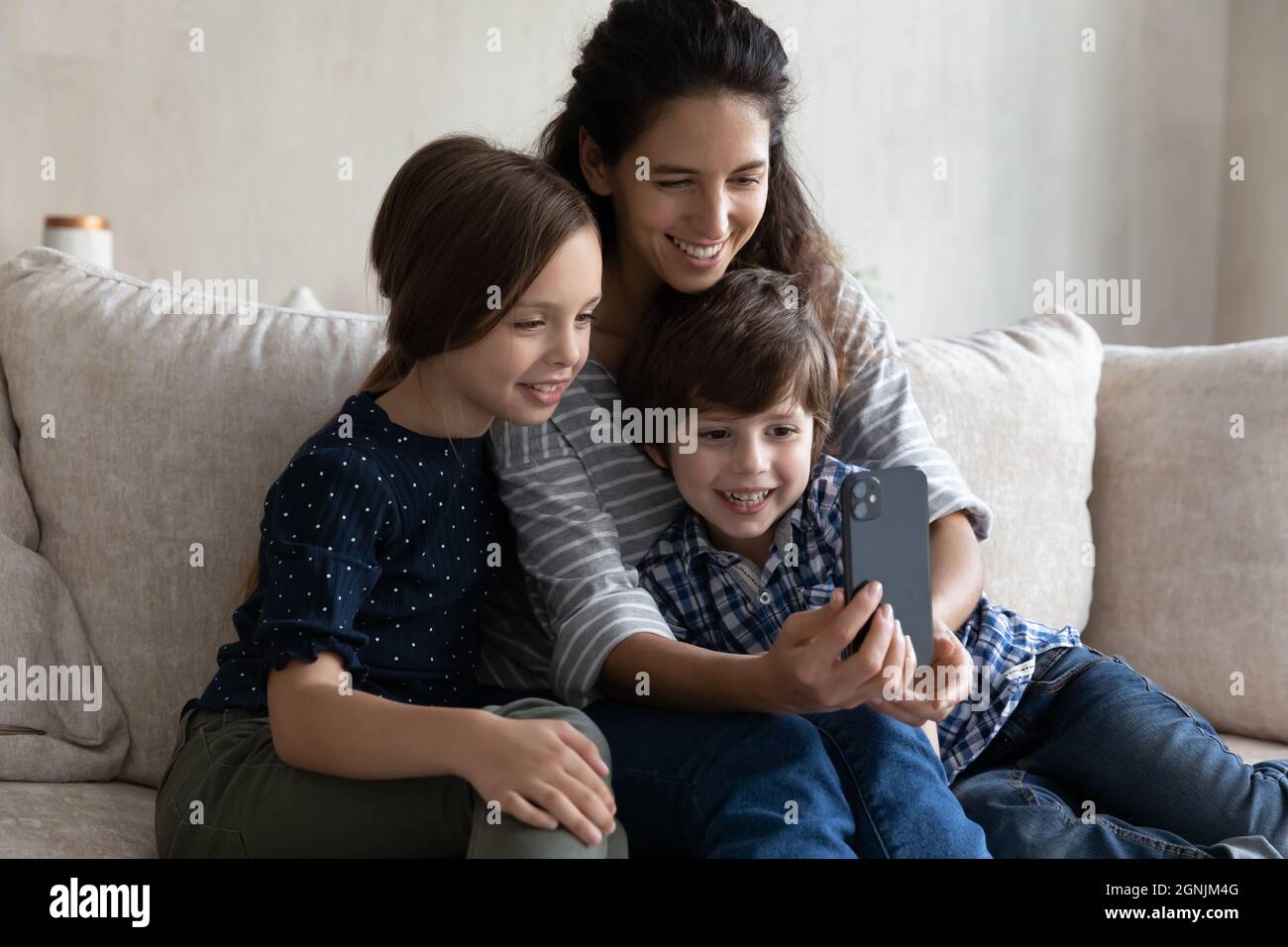 Happy family using cellphone on weekend at home Stock Photo - Alamy