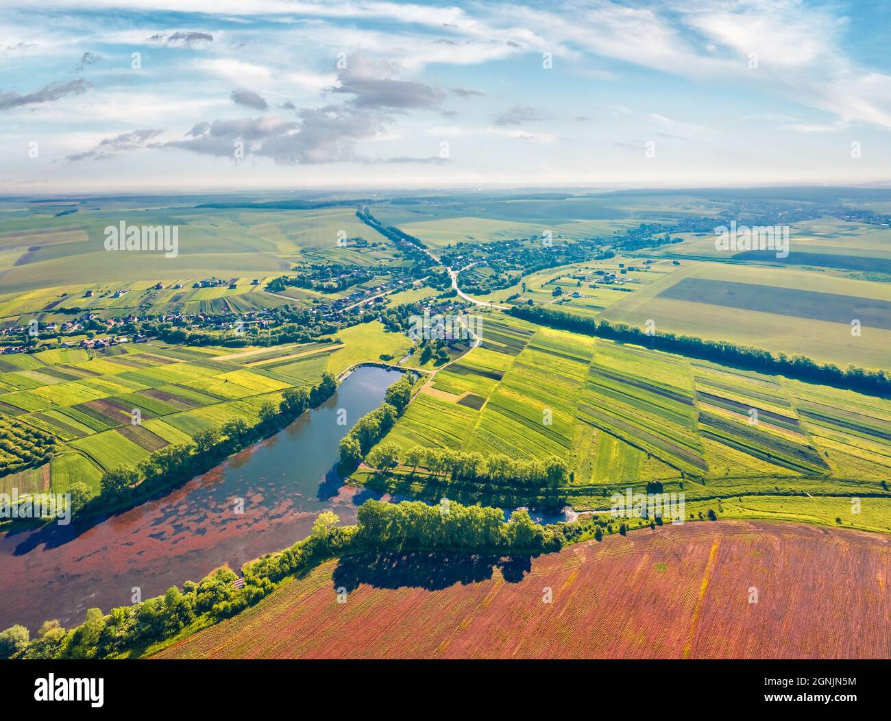 View from flying drone of Pochapyntsi pond and village. Bright summer ...