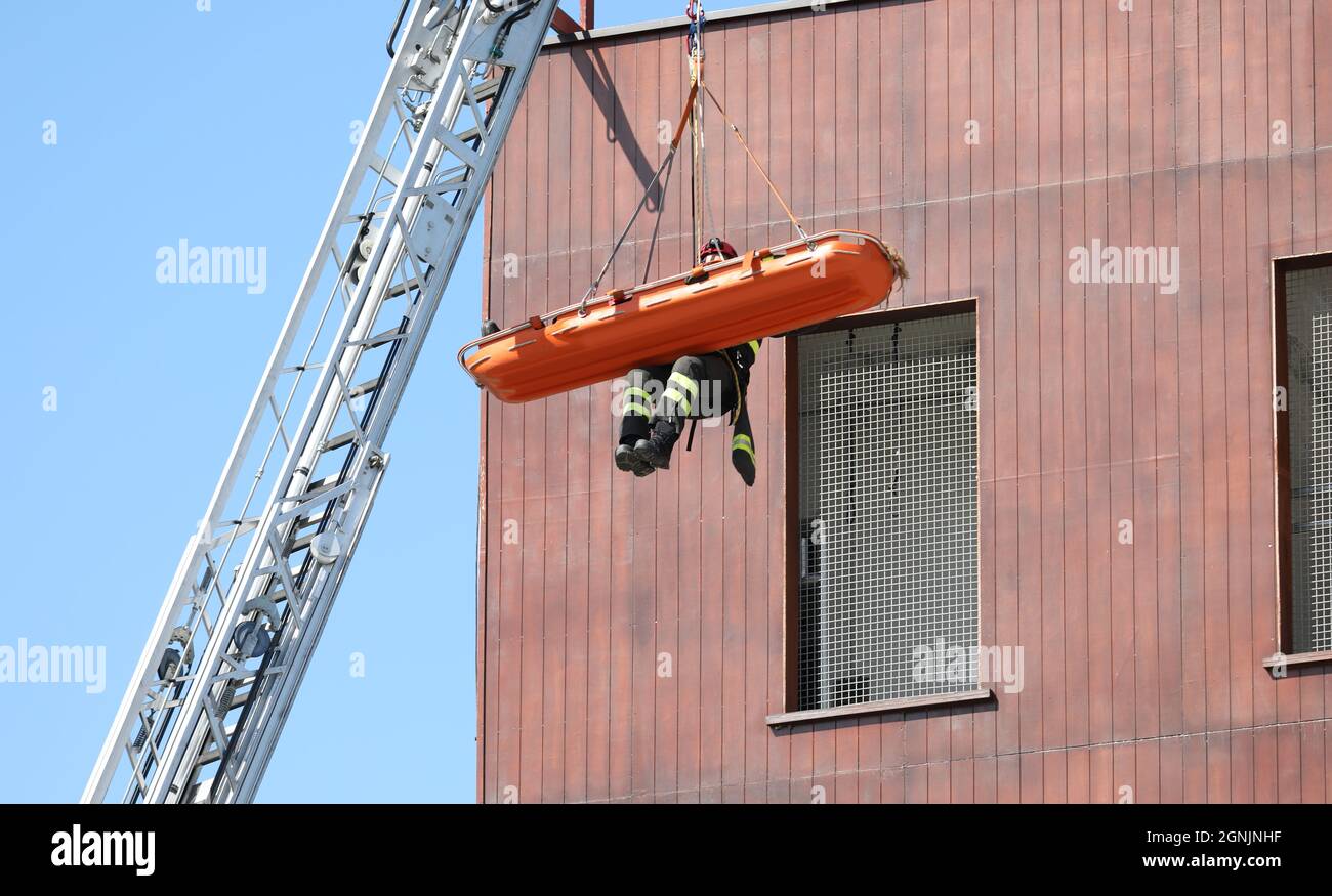 rescue with a special orange stretcher for transporting the injured ...