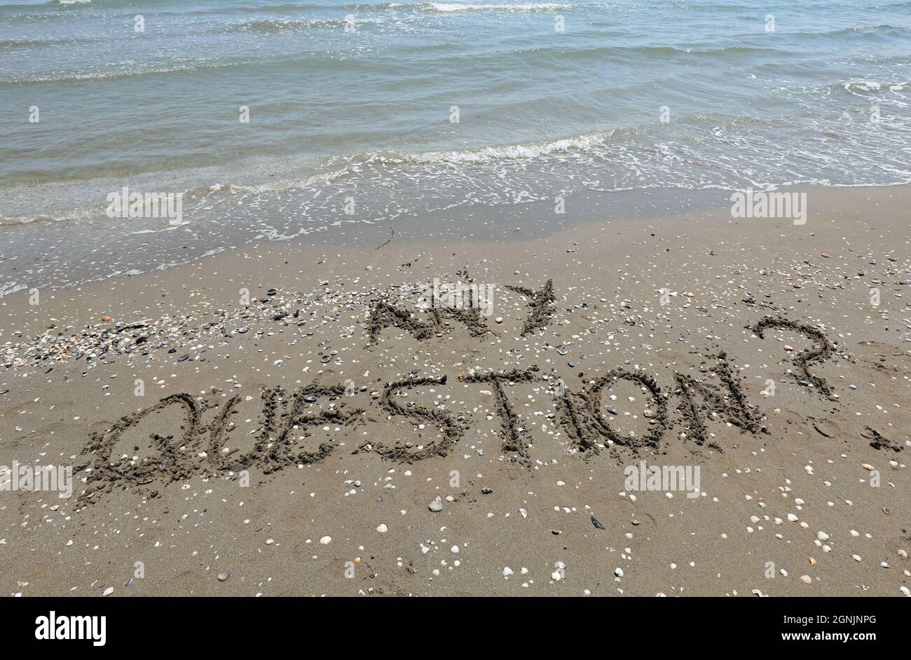 Any Question text on the beach by the sea Stock Photo - Alamy