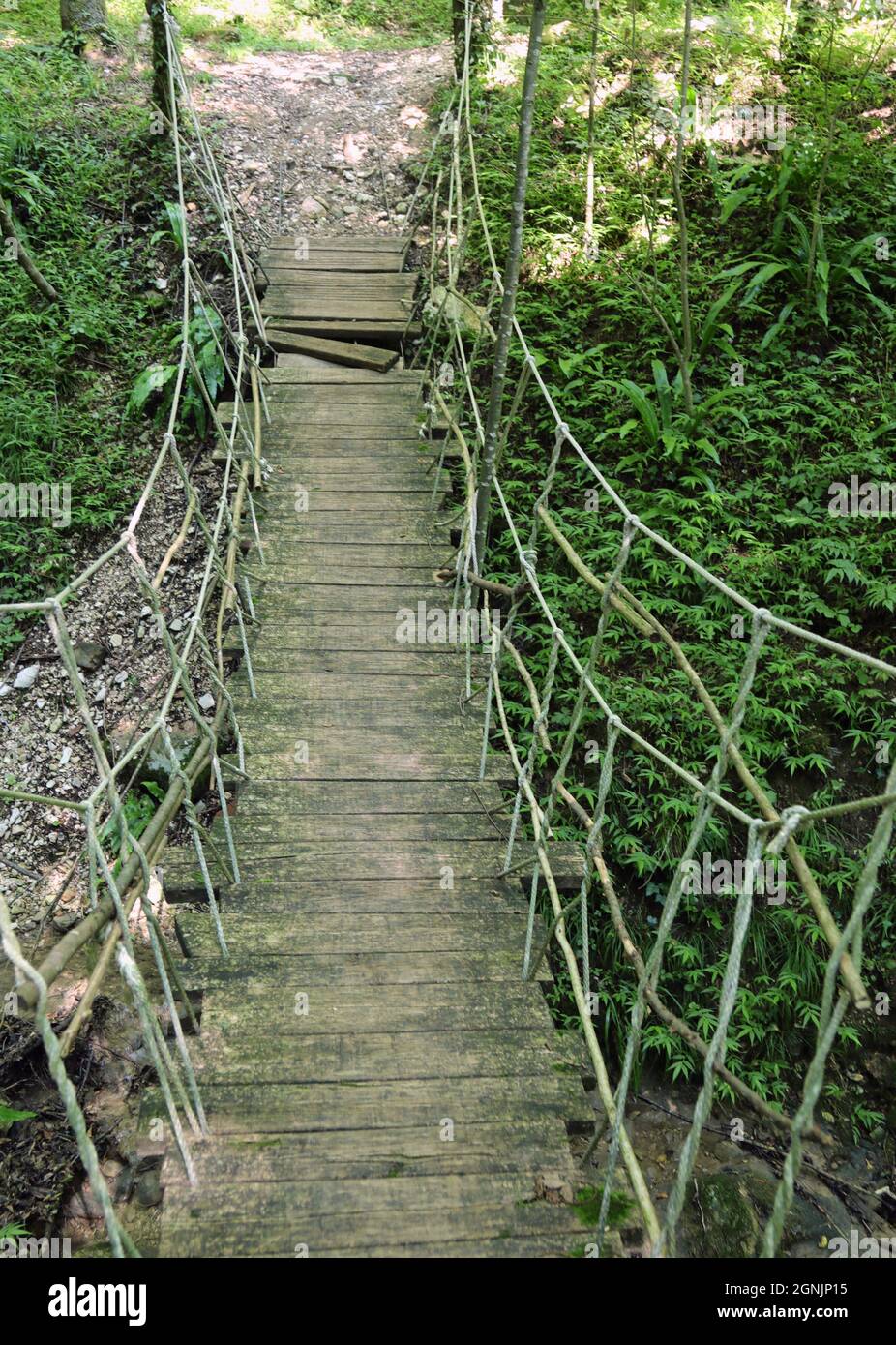 ancient suspension Tibetan rope bridge and wooden asi in the middle of ...