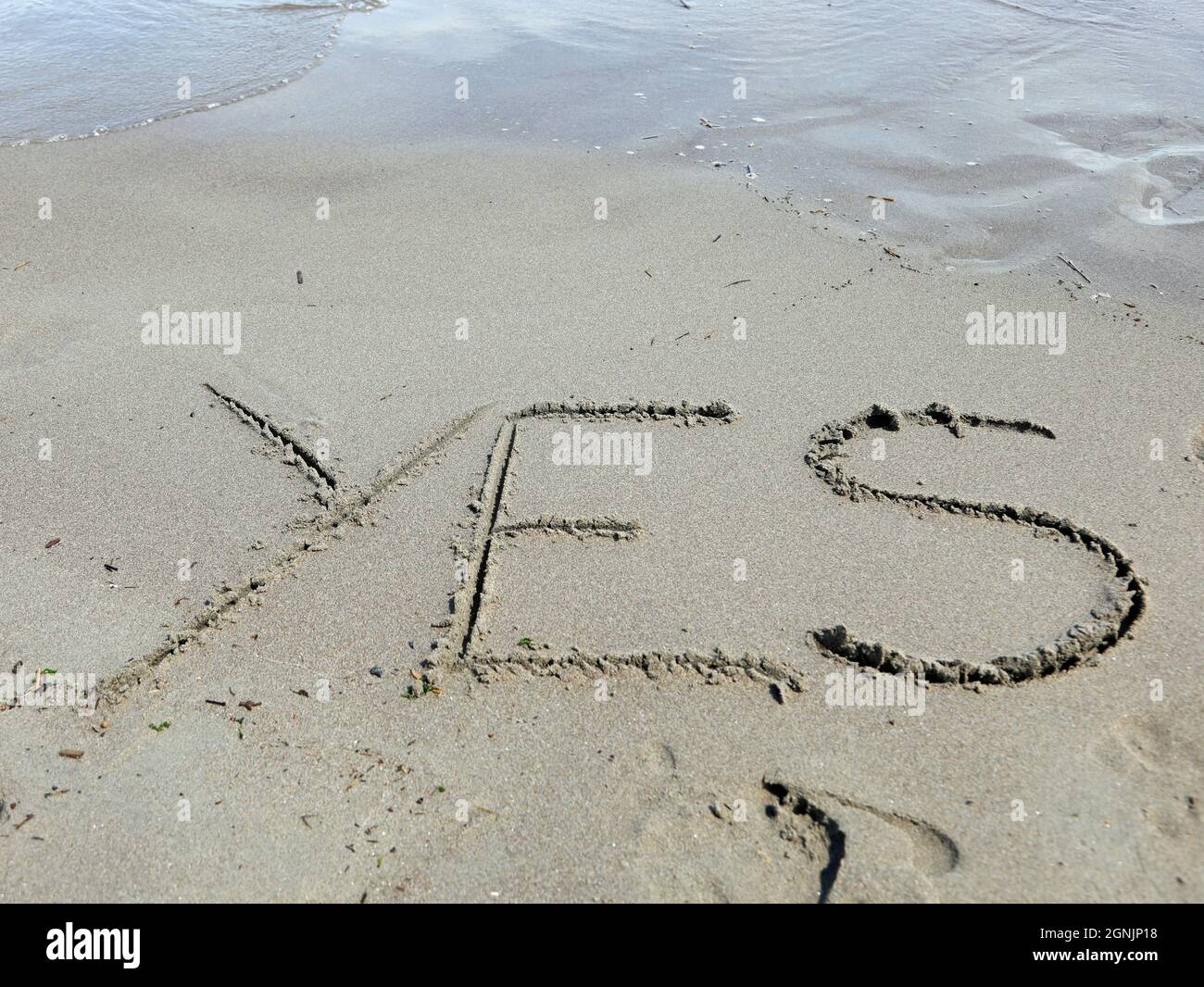 big text YES on the beach by the sea Stock Photo - Alamy