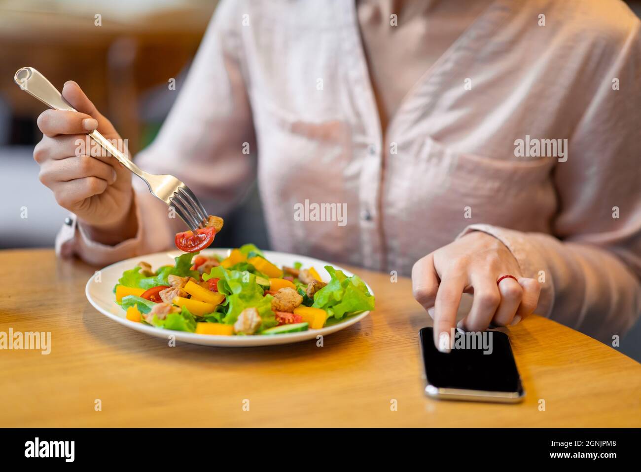 Calories counting and food control concept. Woman using smartphone with ...
