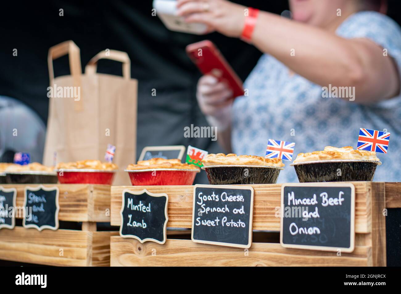 Pies and food being sold at a market in the UK with British English ...